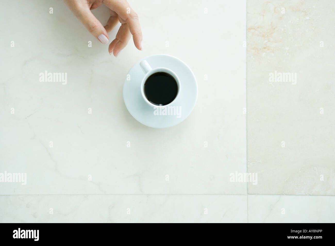 Hand reaching for coffee cup, viewed from directly above Stock Photo ...