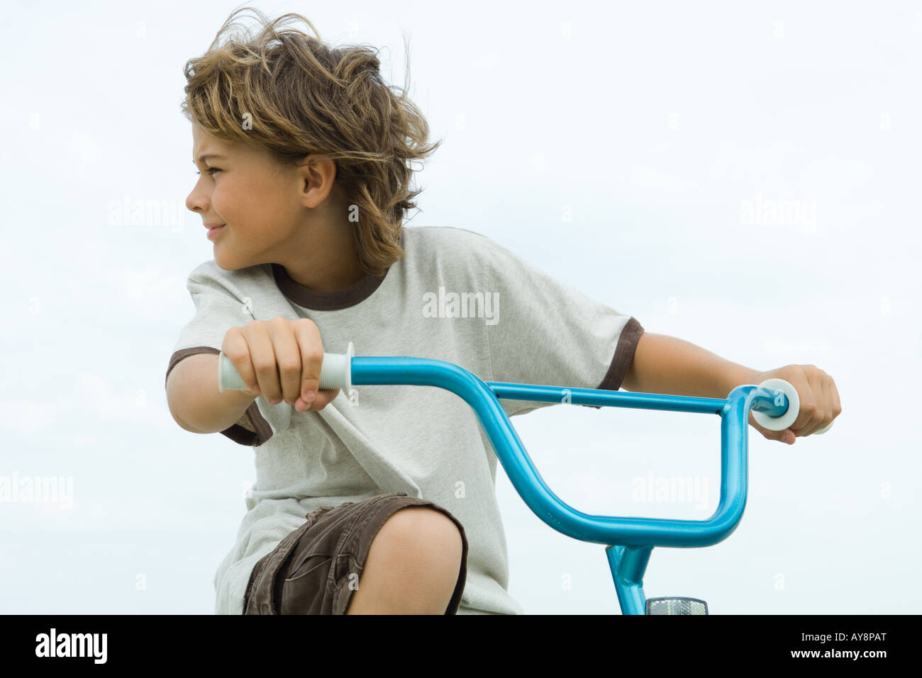 Boy riding bicycle, looking over shoulder, close-up Stock Photo - Alamy