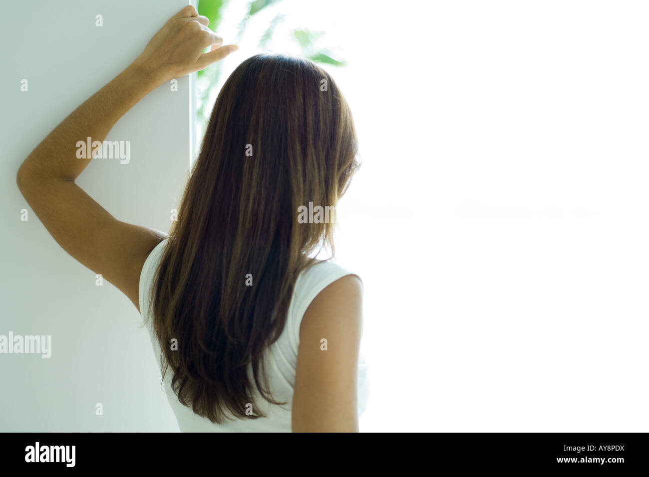 Woman looking out window, rear view, close-up Stock Photo - Alamy