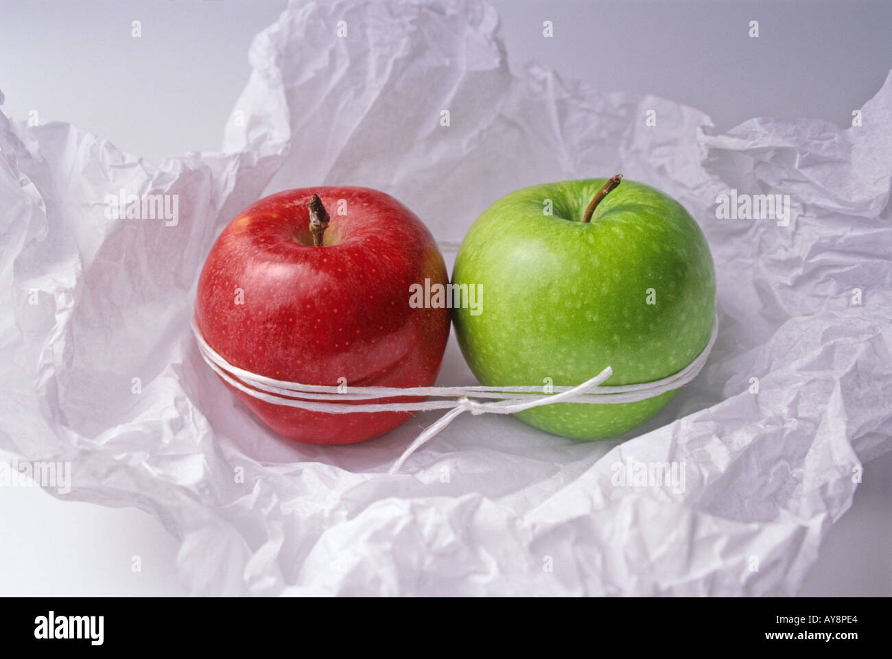 "Red apple, green apple, "tied together" with string, wrapped in tissue ...