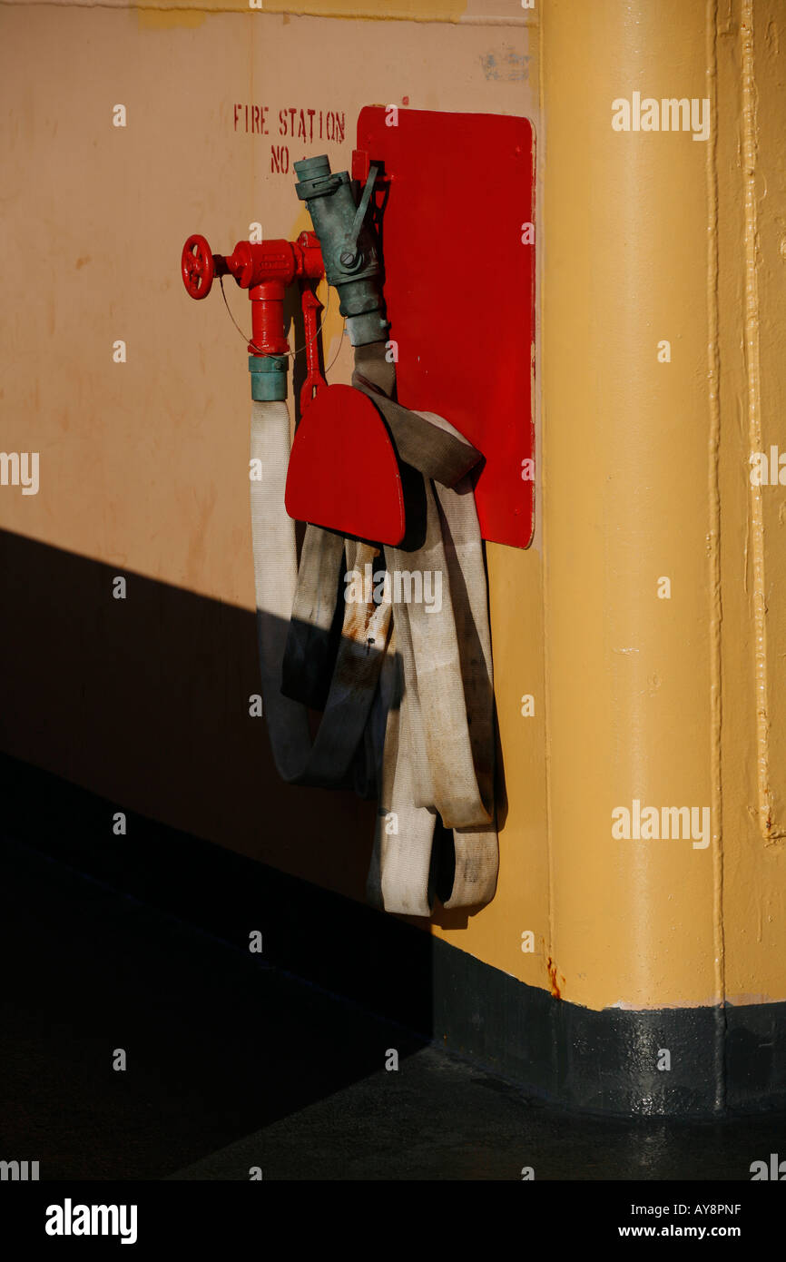 Fire hose on ship on yellow metal Stock Photo - Alamy
