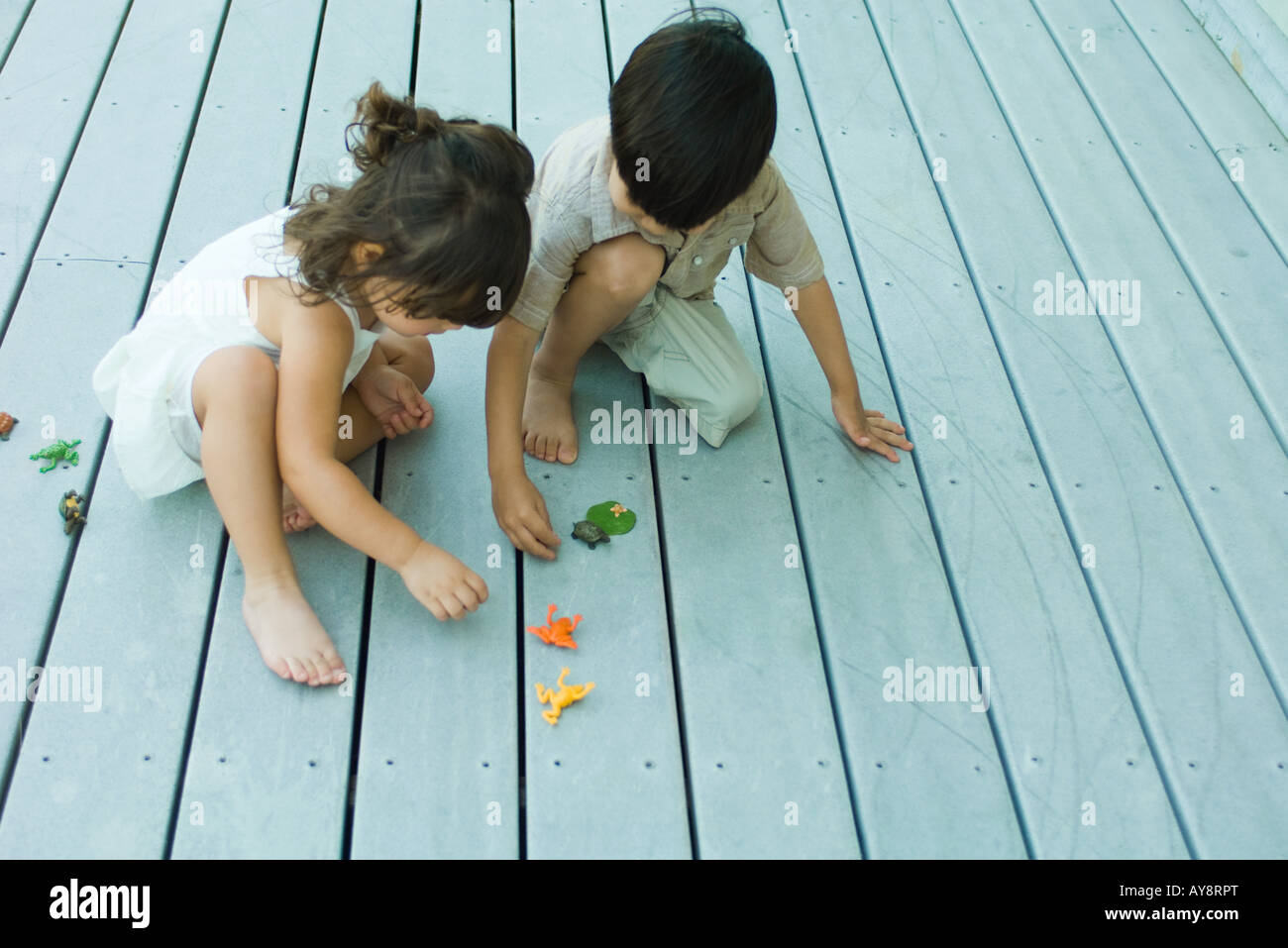 Little girl crouching on floor hi-res stock photography and images - Alamy
