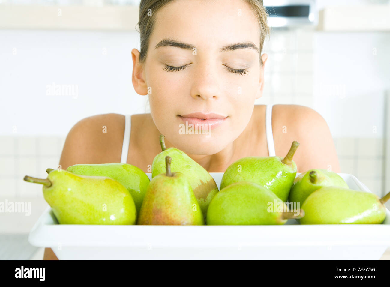 Young woman smelling fresh pears, eyes closed, close-up Stock Photo - Alamy