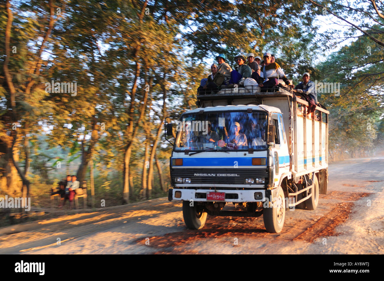 Truck loaded with people on a dusty road Pyay Myanmar Stock Photo - Alamy