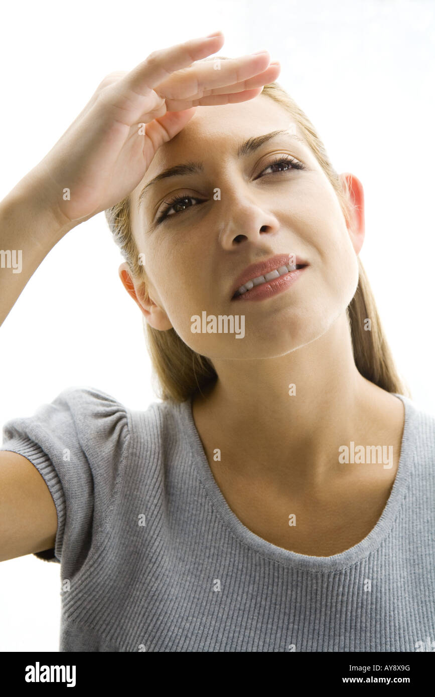 Blonde woman shading eyes, portrait Stock Photo - Alamy