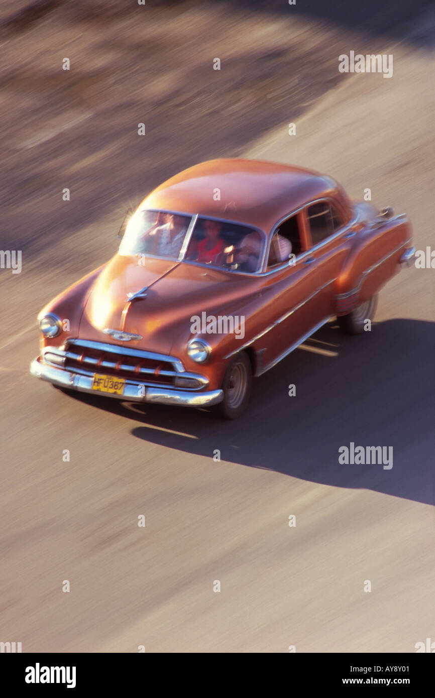 Classic 1950s car zipping through the streets of Havana, Cuba Stock ...