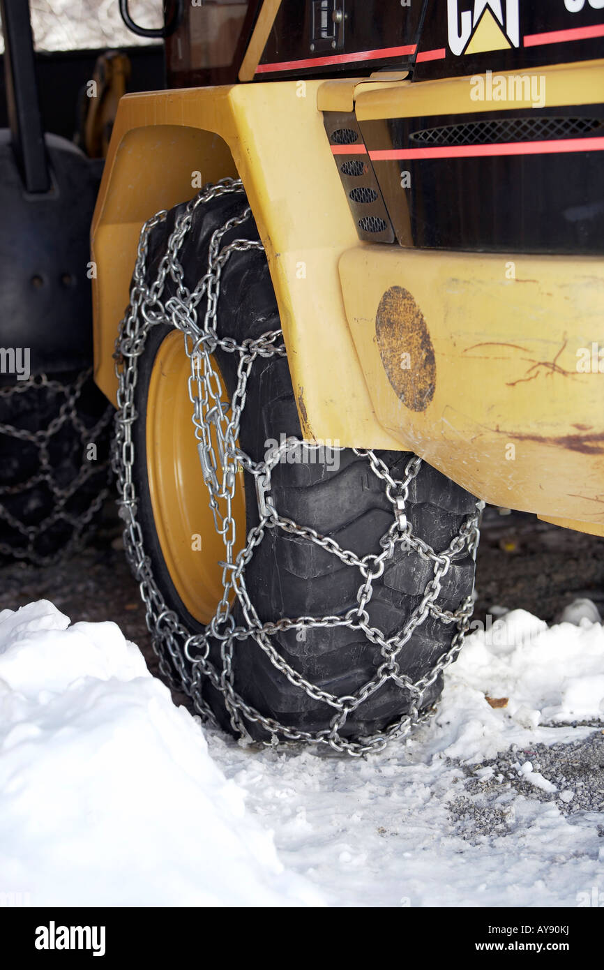 Snow chains, attached to snow plough tractor Stock Photo - Alamy