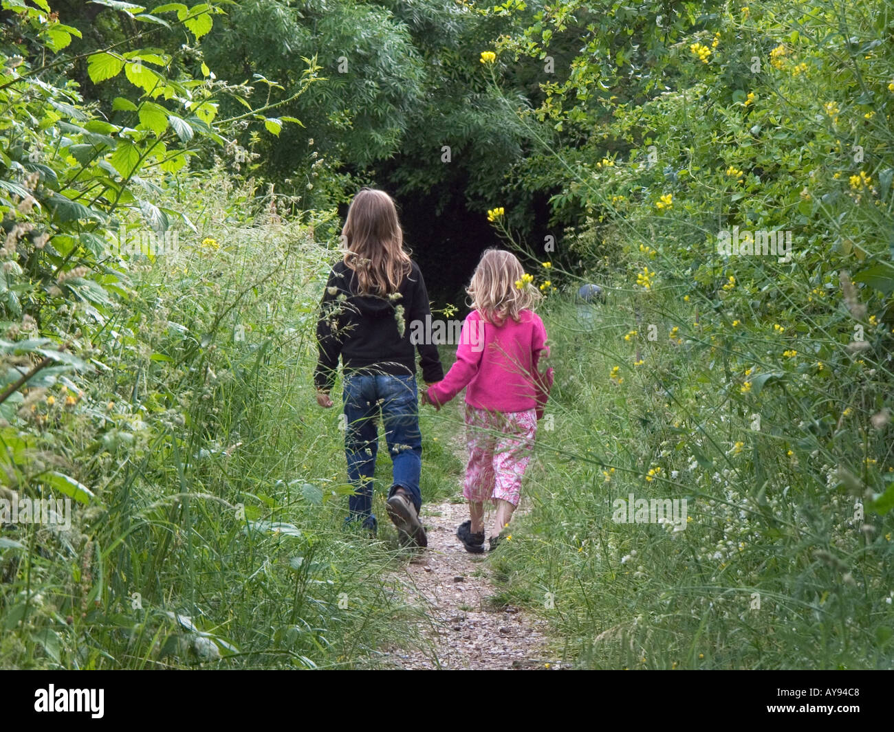 children walking hand in hand Stock Photo - Alamy