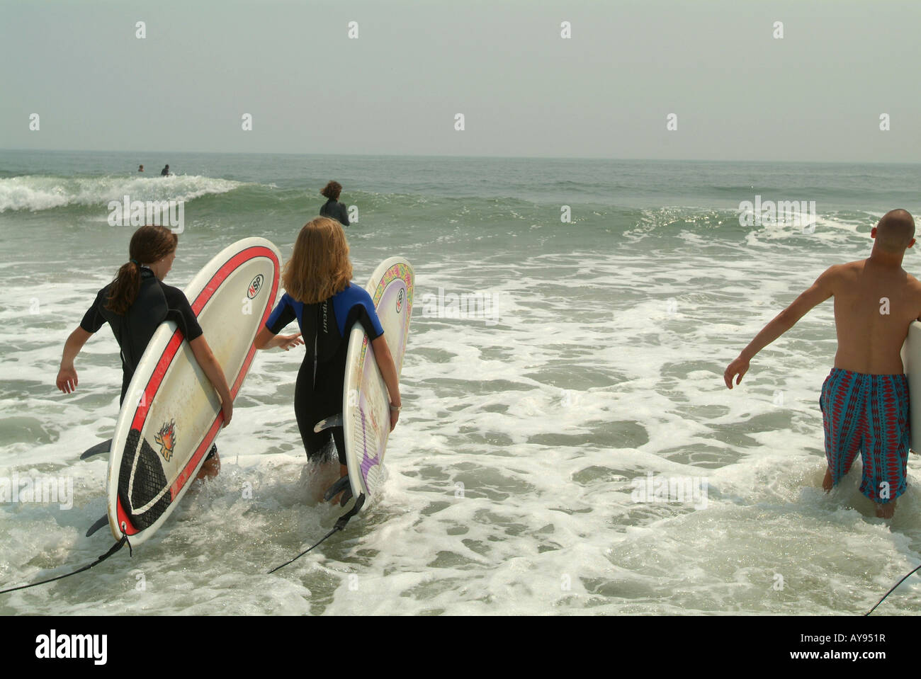 The young students are given a quick lesson on the beach before heading ...