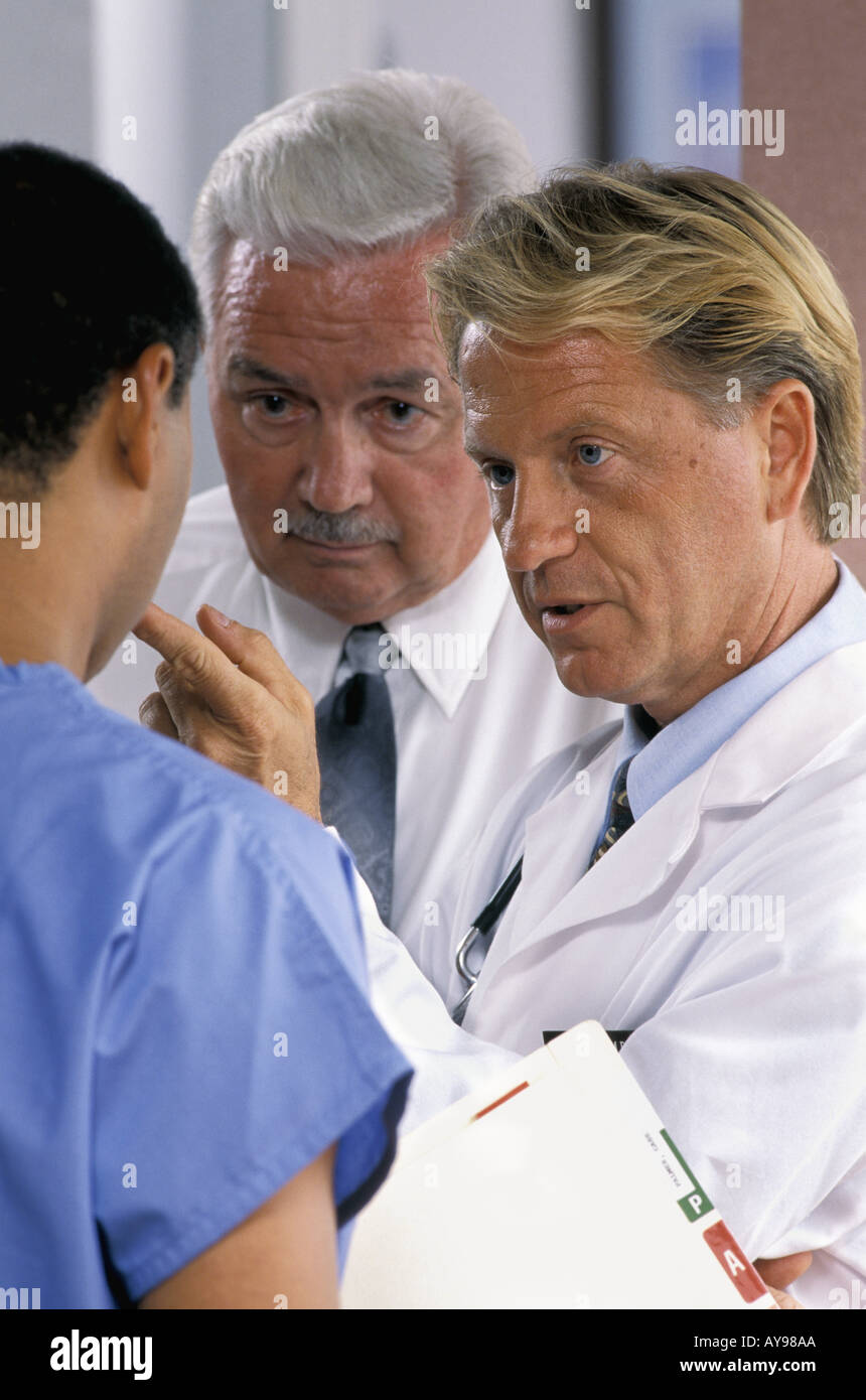 Medical conference with Three doctors meeting talking about a patient ...