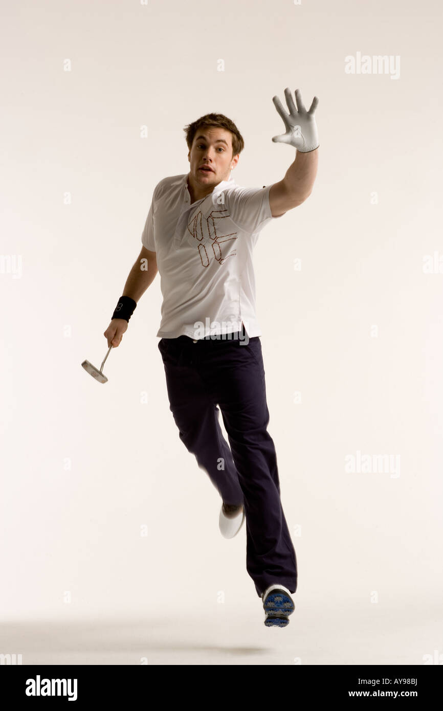 MALE GOLFER WITH HAND RAISED Stock Photo - Alamy