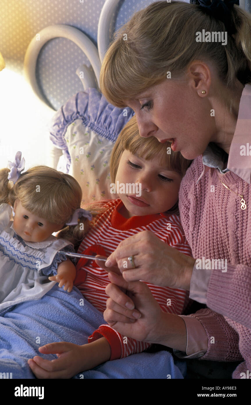 Mother talking temperature of Daughter with cold looking at thermometer ...