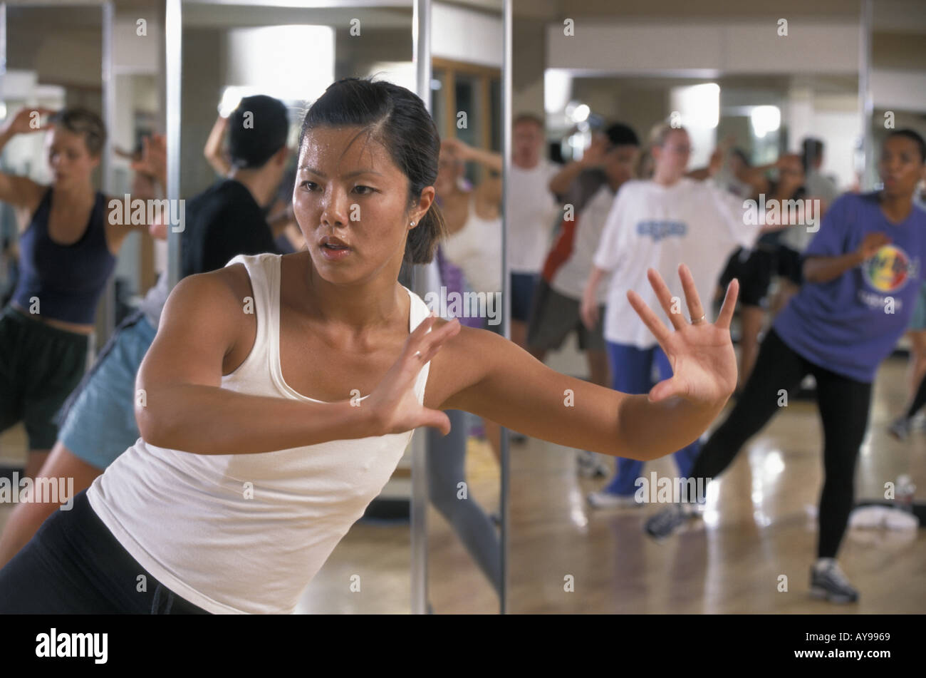 Asian American woman exercising in health club Tai Bo class Stock Photo ...