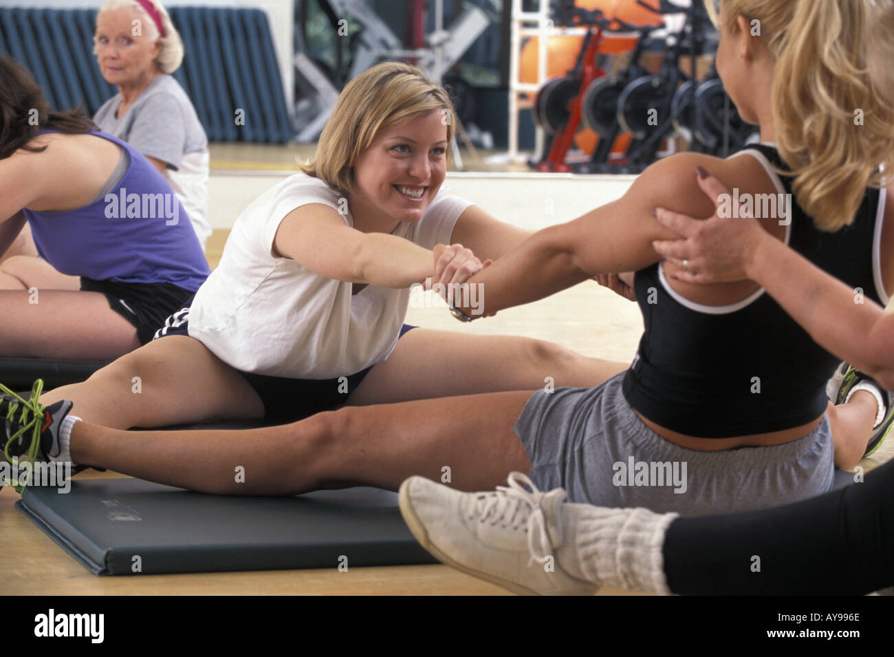 Women stretching at health club gym before exercise class Stock Photo ...