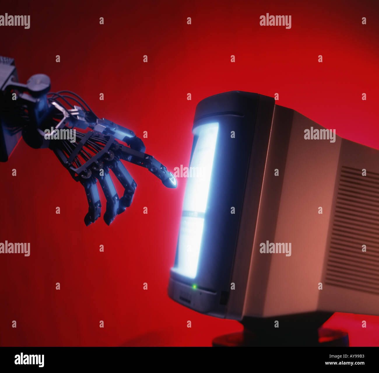 Articulated robotic hand pointing at computer screen Stock Photo - Alamy