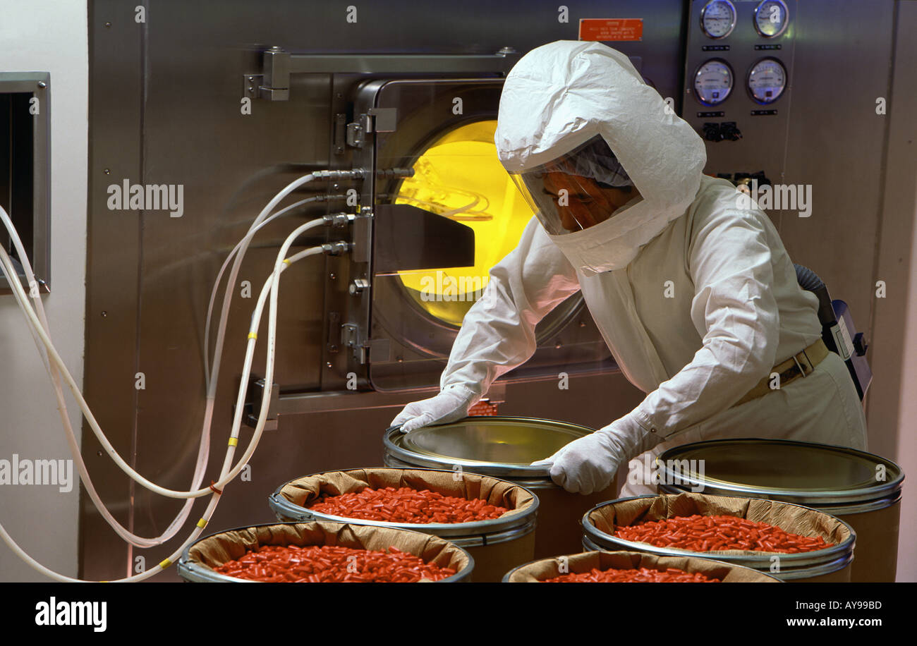 Pharmaceutical manufacturing worker packaging pills in a clean room ...
