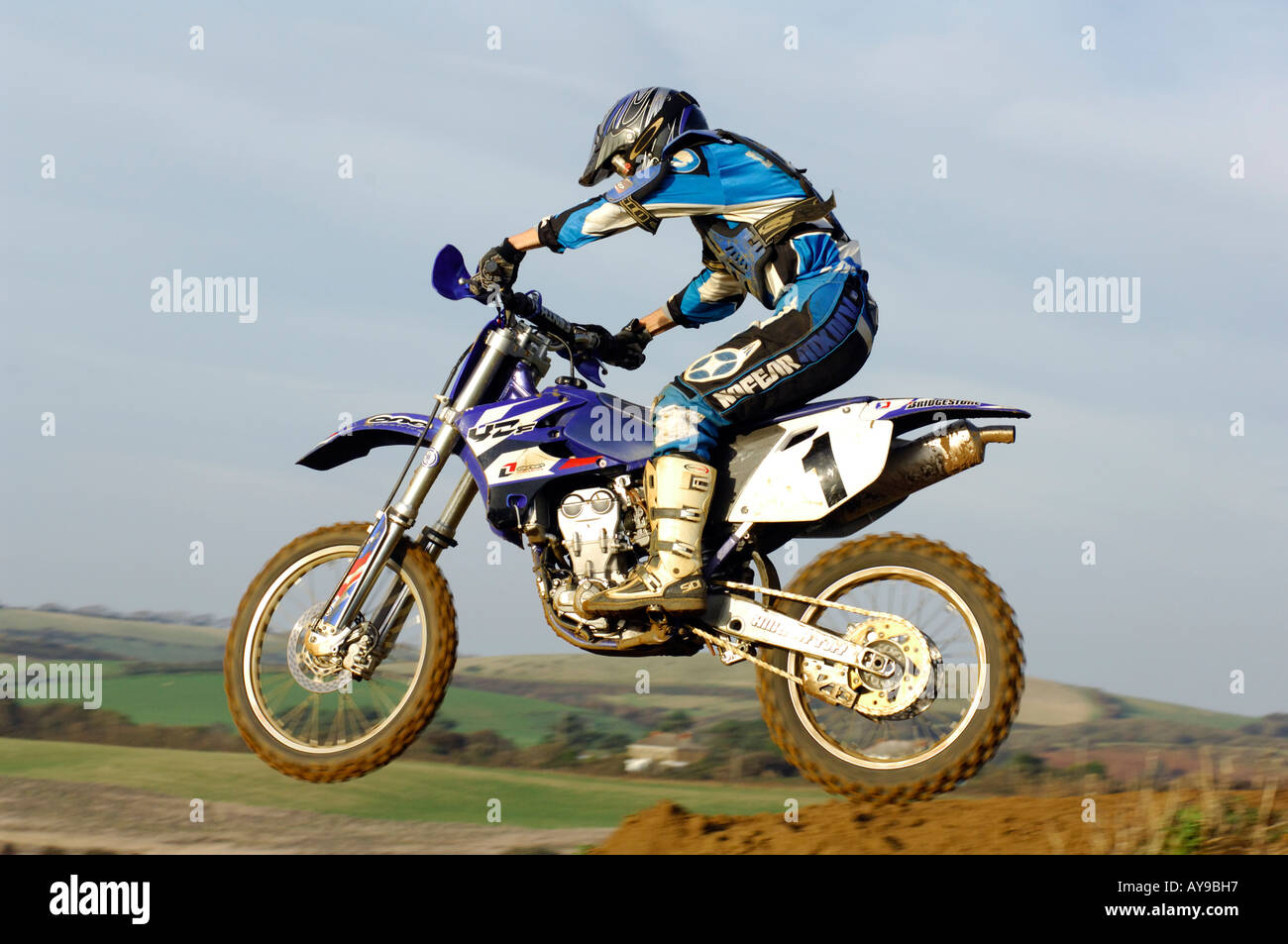 a guy rider on a motocross bile motorcycle jumping and racing big air ...