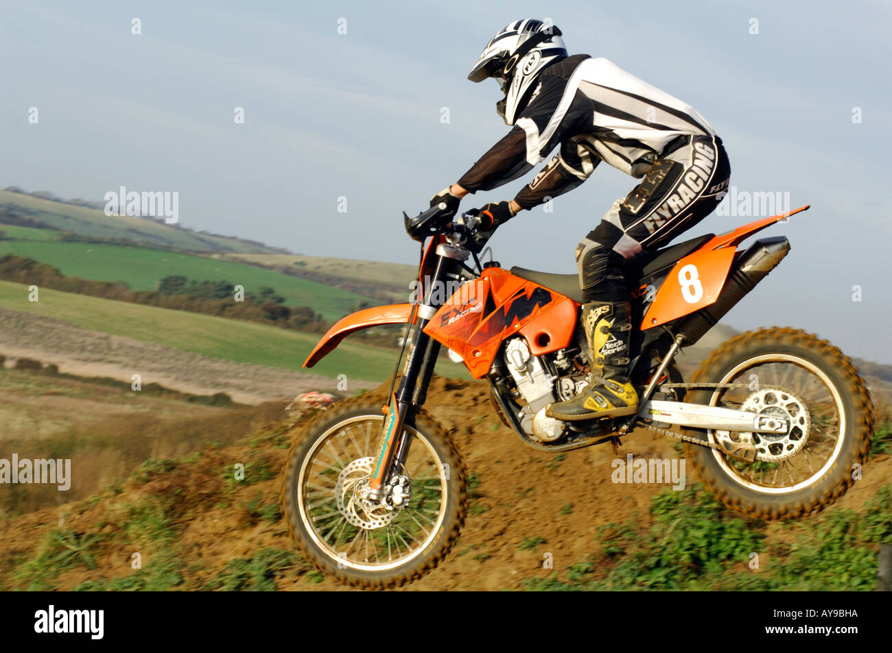 a guy rider on a motocross bile motorcycle jumping and racing big air ...