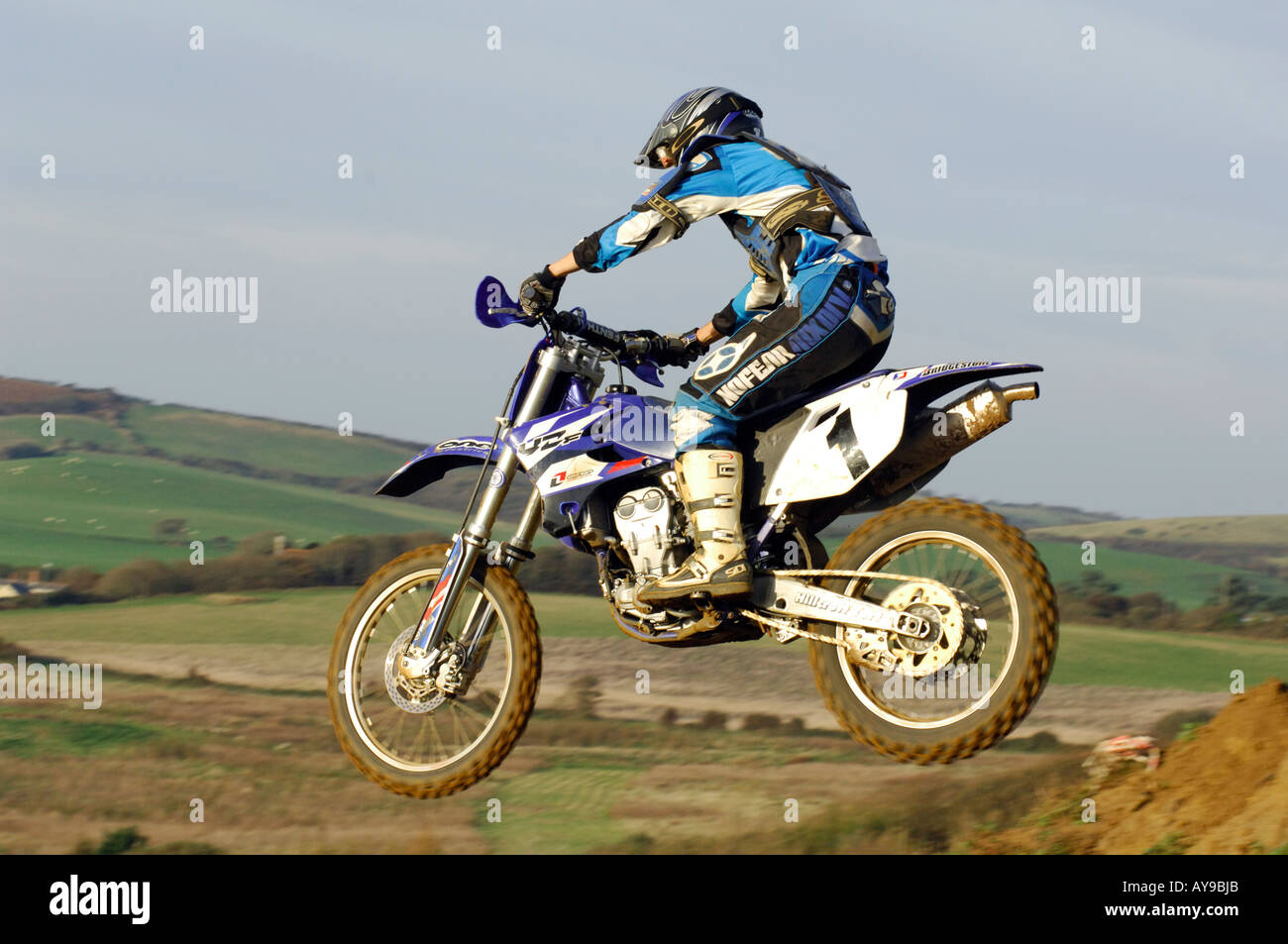a guy rider on a motocross bile motorcycle jumping and racing big air ...
