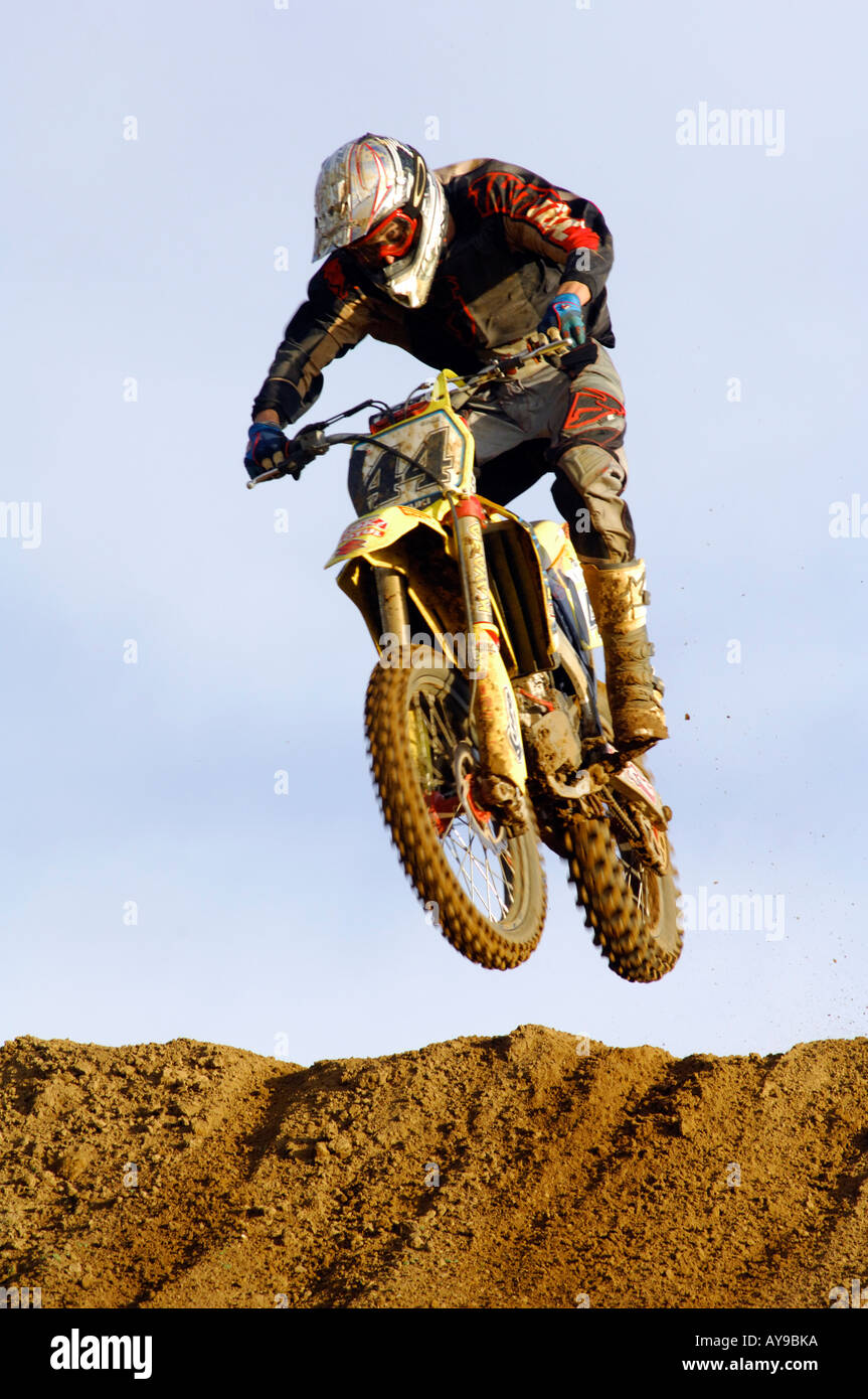 a guy rider on a motocross bile motorcycle jumping and racing big air ...