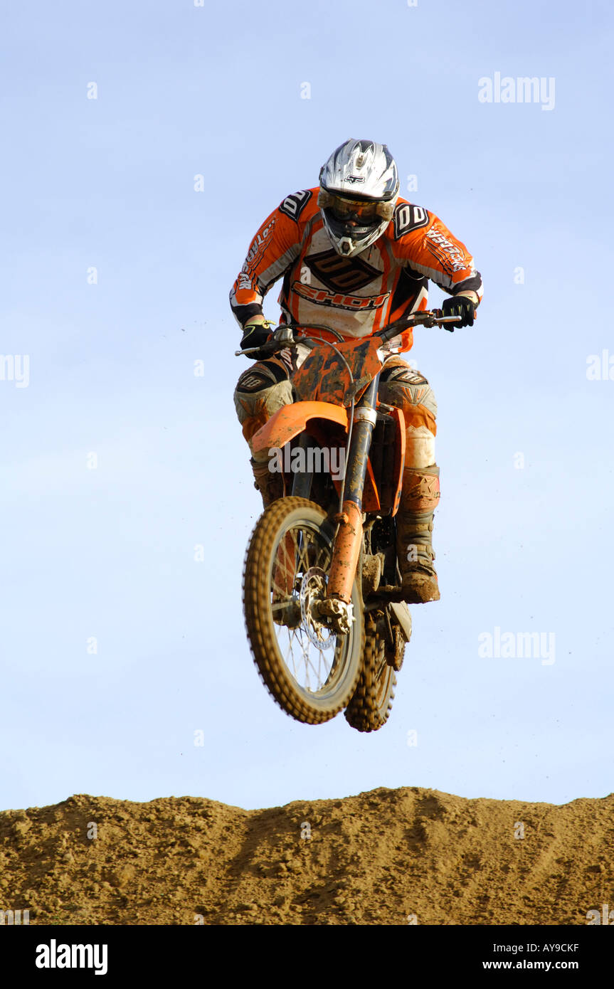 a guy rider on a motocross bile motorcycle jumping and racing big air ...