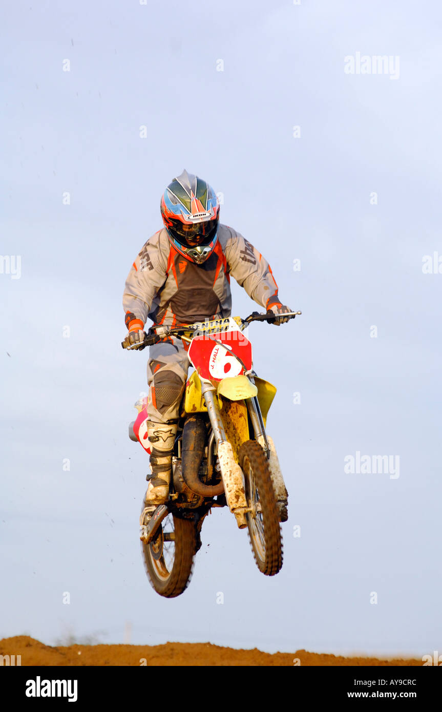 a guy rider on a motocross bile motorcycle jumping and racing big air ...