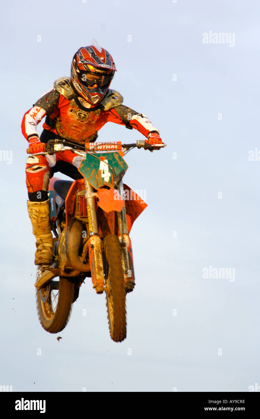 a guy rider on a motocross bile motorcycle jumping and racing big air ...