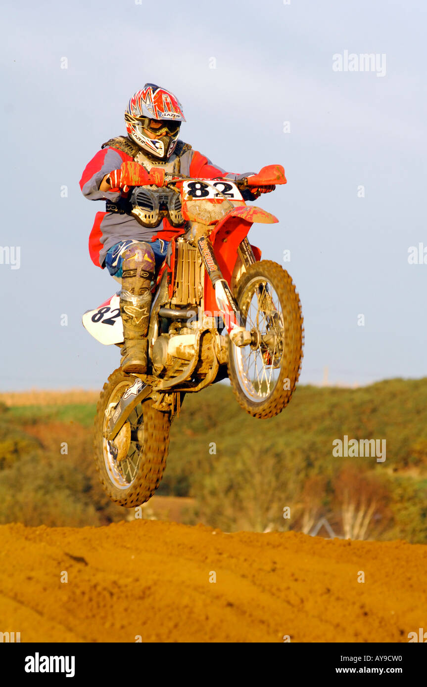 a guy rider on a motocross bile motorcycle jumping and racing big air ...