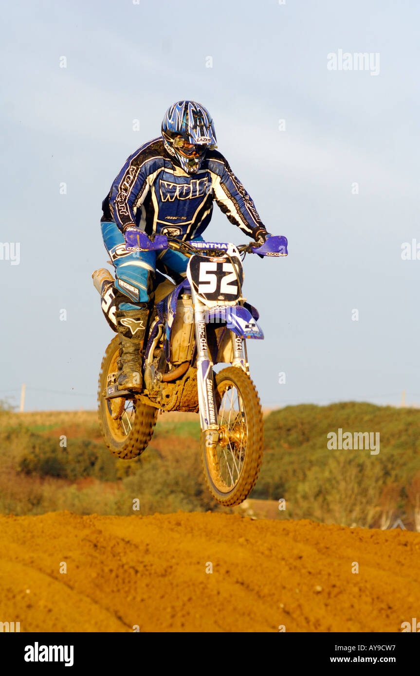 a guy rider on a motocross bile motorcycle jumping and racing big air ...