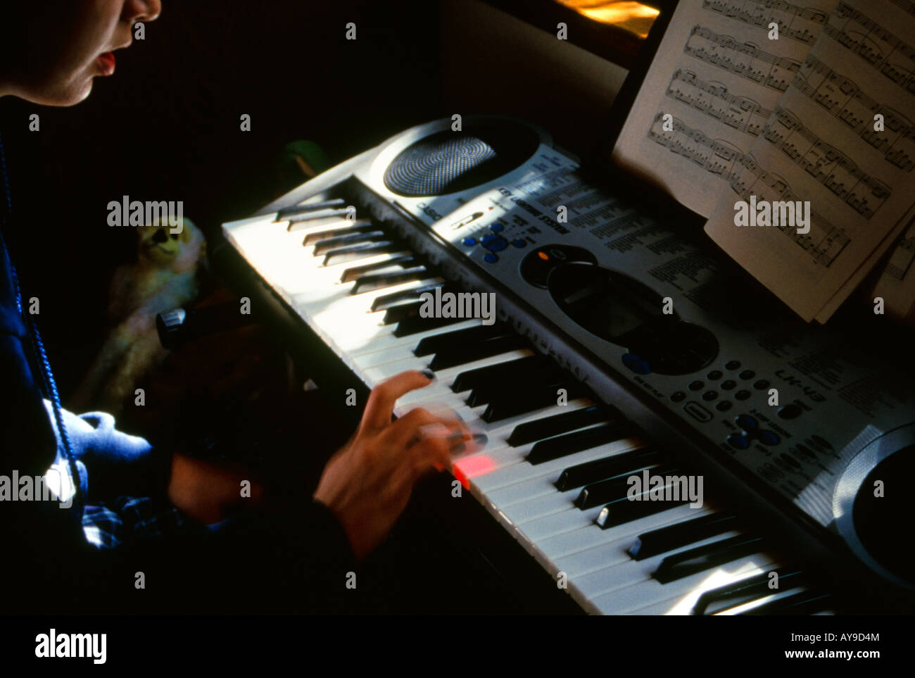 Girl at electric keyboard synthesizer Stock Photo - Alamy