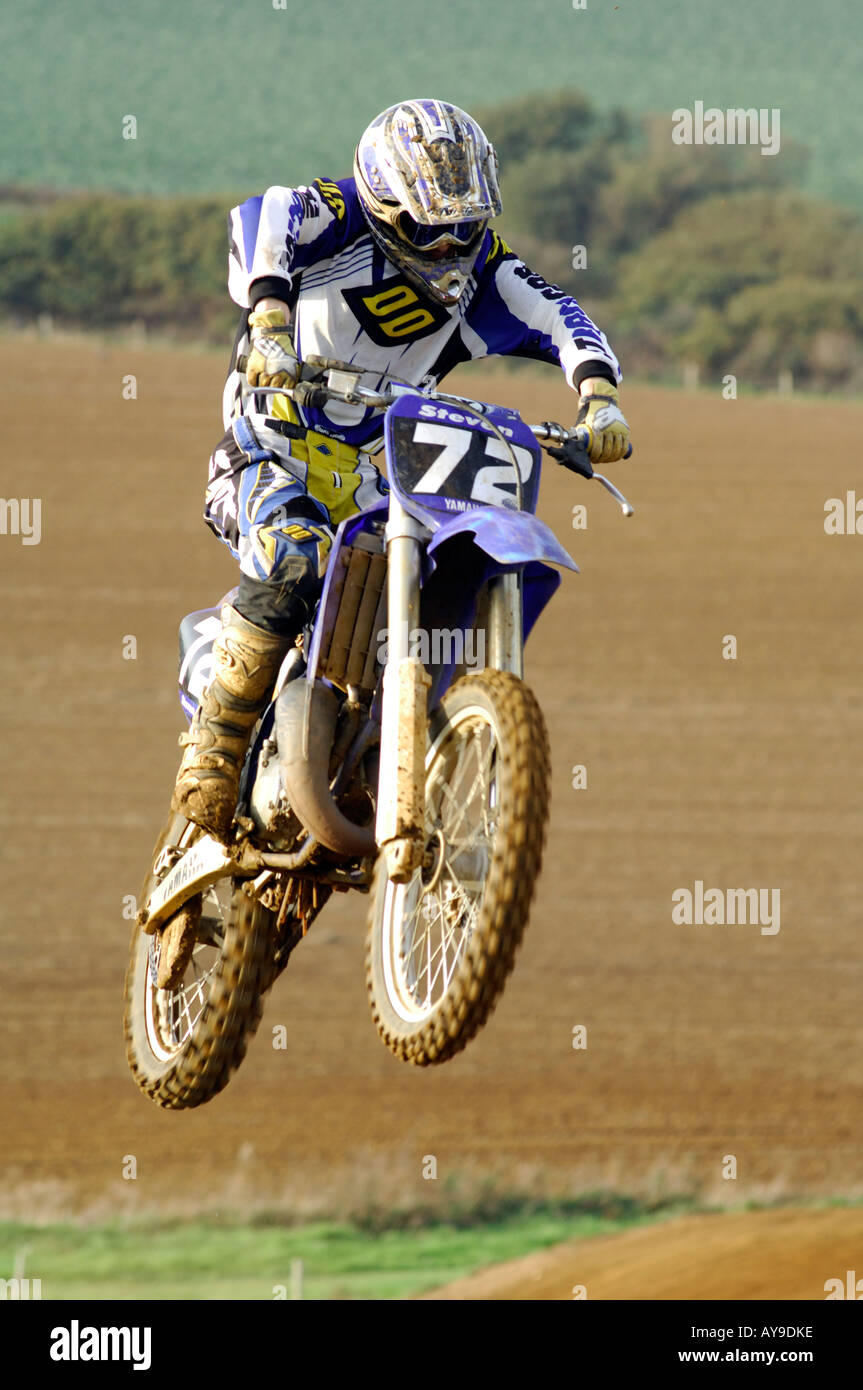 a guy rider on a motocross bile motorcycle jumping and racing big air ...