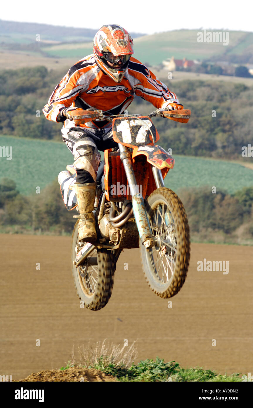 a guy rider on a motocross bile motorcycle jumping and racing big air ...