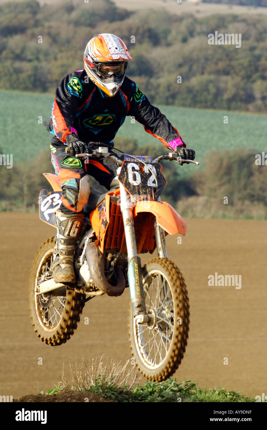 a guy rider on a motocross bile motorcycle jumping and racing big air ...