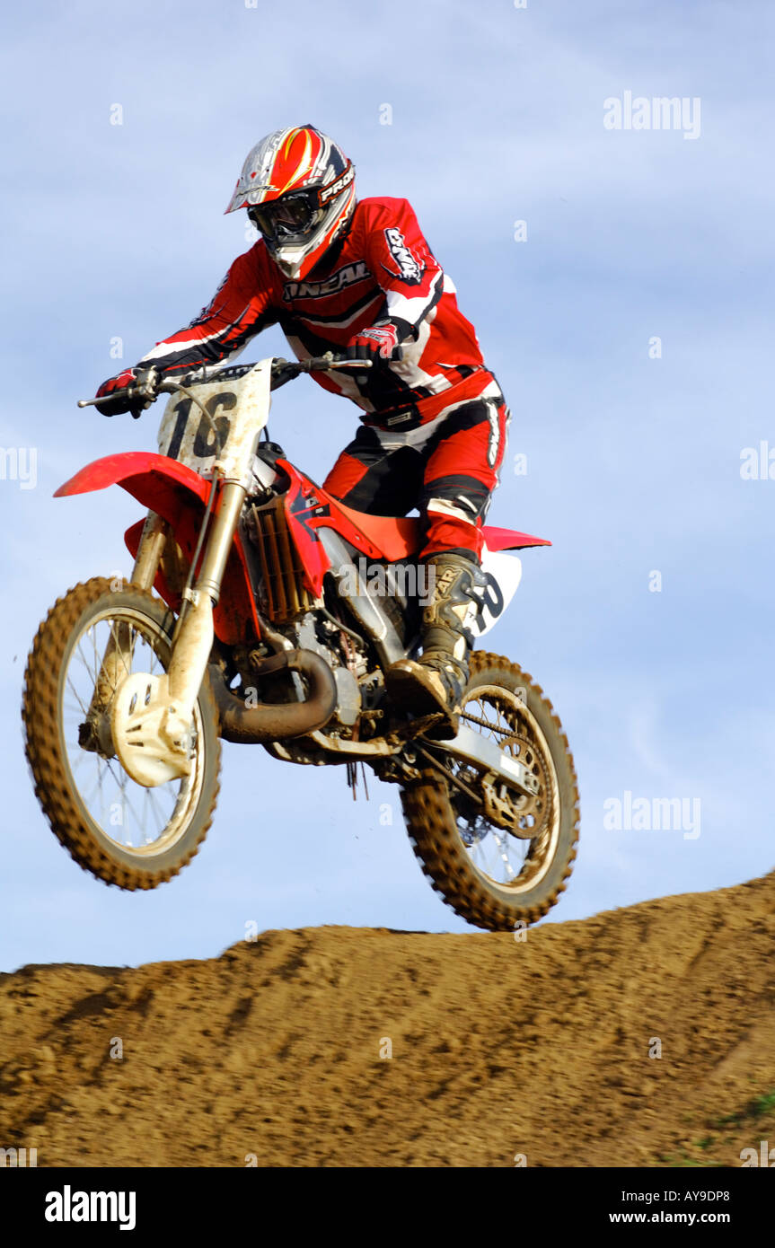 a guy rider on a motocross bile motorcycle jumping and racing big air ...