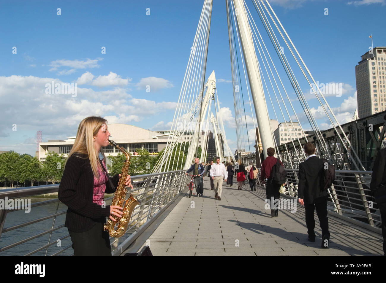 BUSKER PLAYING SAXOPHONE ON GOLDEN JUBILEE BRIDGE, LONDON ENGLAND UK ...
