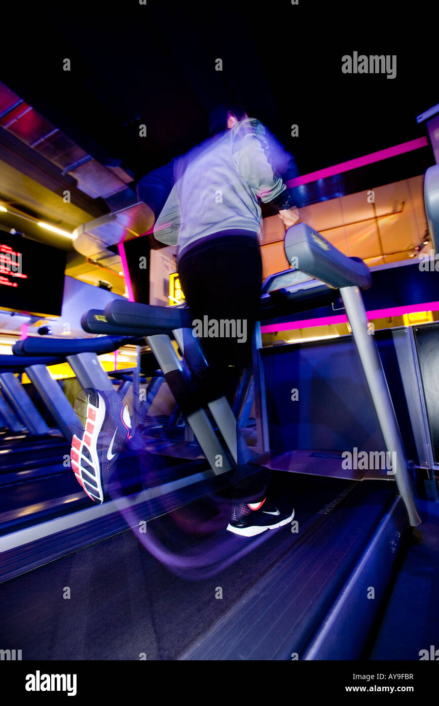 Man on running machine, blurred motion Stock Photo - Alamy