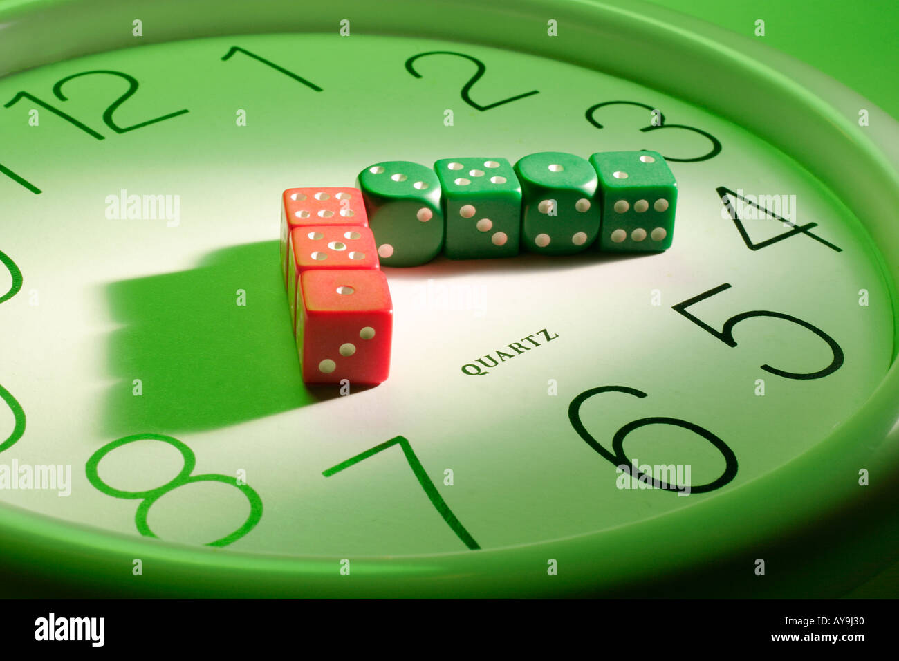 Red and Green Dice on Clock Stock Photo - Alamy