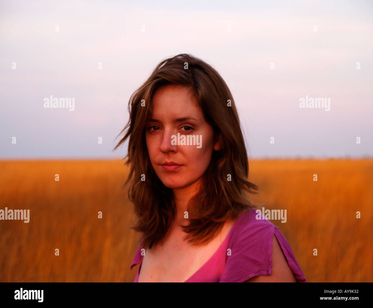 Beautiful young girl in her twenties with demure expression ...