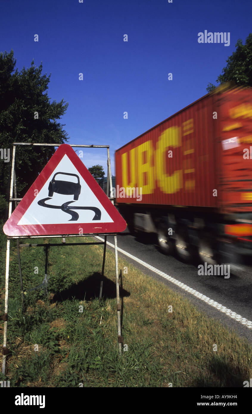 lorry passing warning sign of slippery road surface ahead uk Stock ...