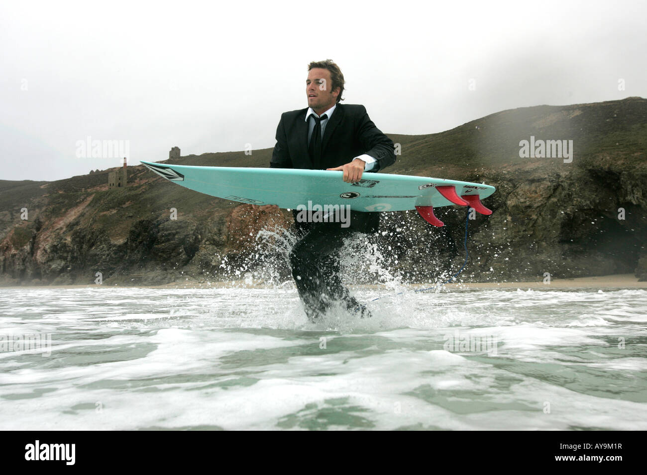 SURFER JOSS ASH SURFING IN A SUIT Stock Photo - Alamy