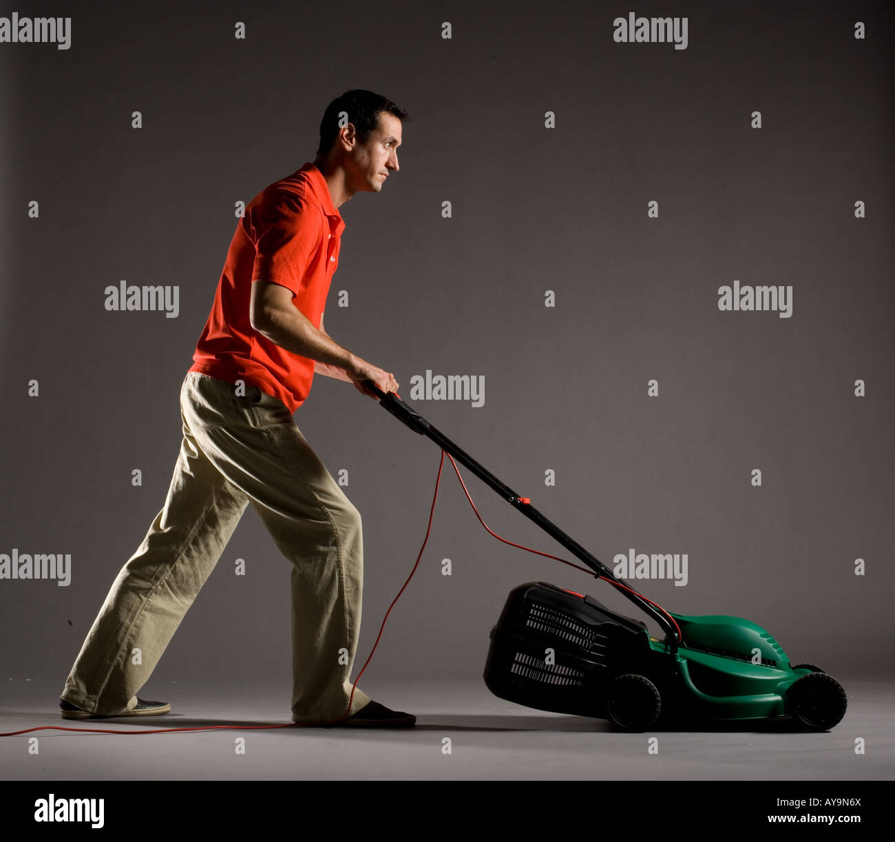 MAN PUSHING BLACK & DECKER LAWNMOWER Stock Photo - Alamy