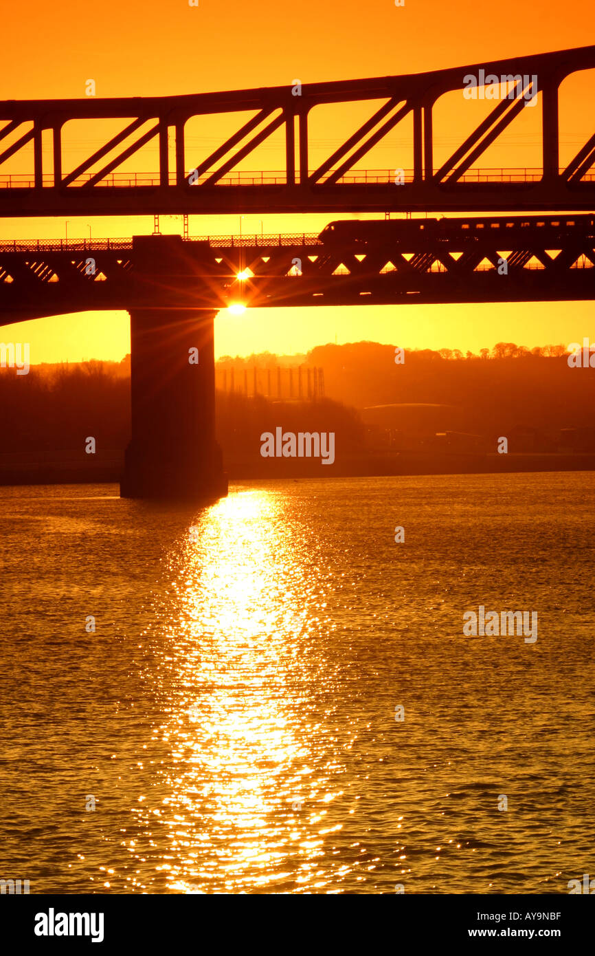 Train crossing the King Edward Bridge at sunset with the Queen ...