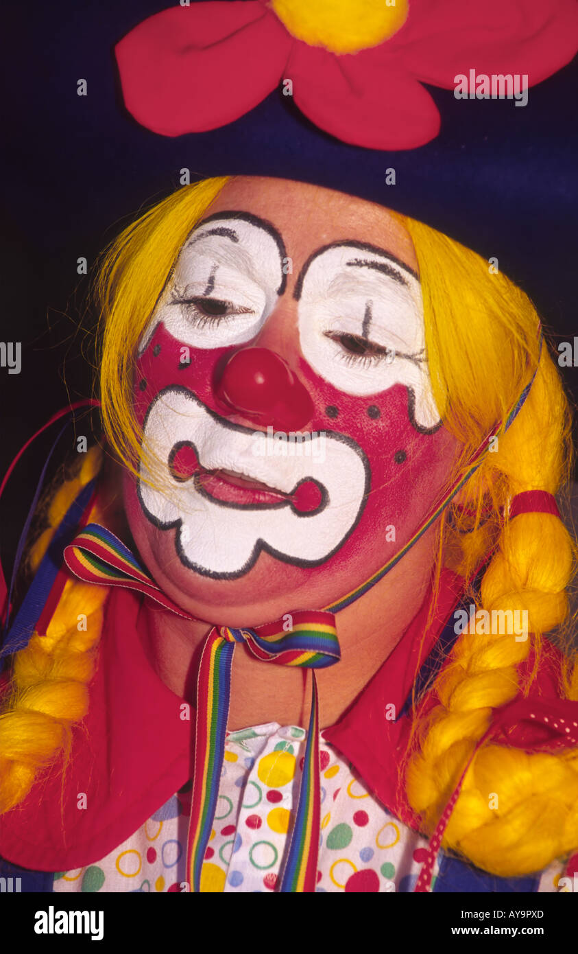A colorful clown entertains kids of all ages, during fiesta at Saint ...