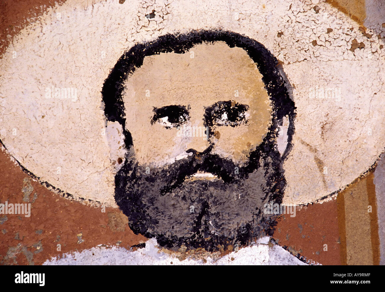 A mural on an old adobe building, depicting days gone by, slowly fades ...