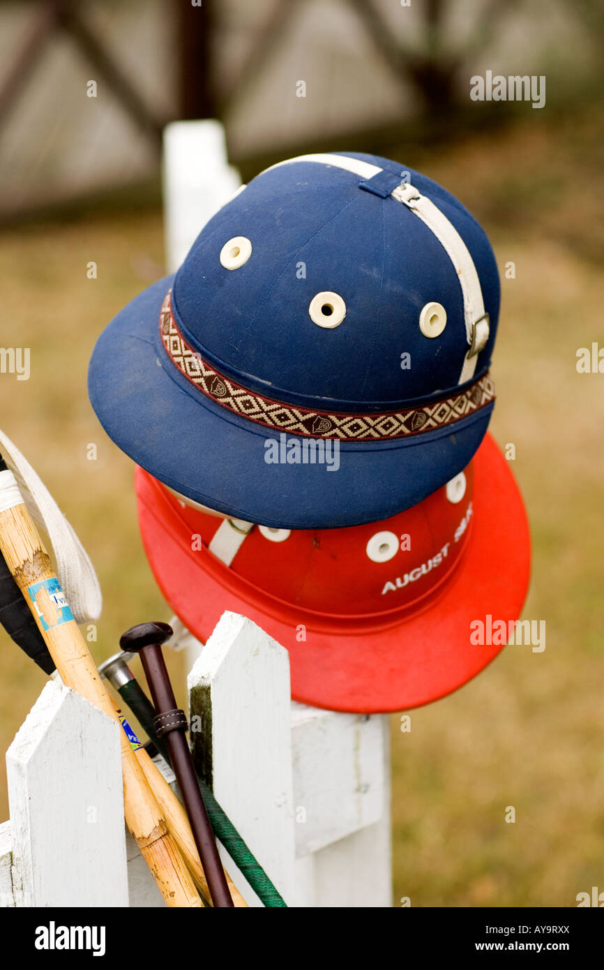 Polo helmets and mallets with riding whip Stock Photo - Alamy