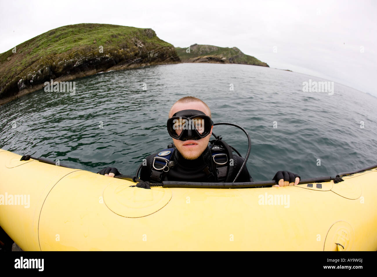 Scuba diver in mask on side of boat, Pembrokeshire, Wales Stock Photo ...