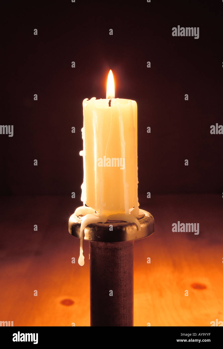 Candlestick candle and flame dark background Stock Photo - Alamy