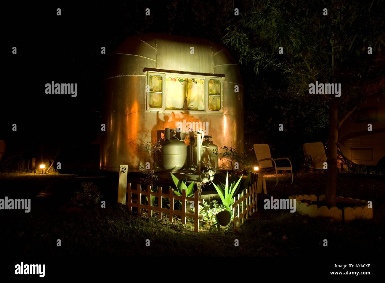 A vintage Airstream trailer glows under the night sky at The Shady Dell ...