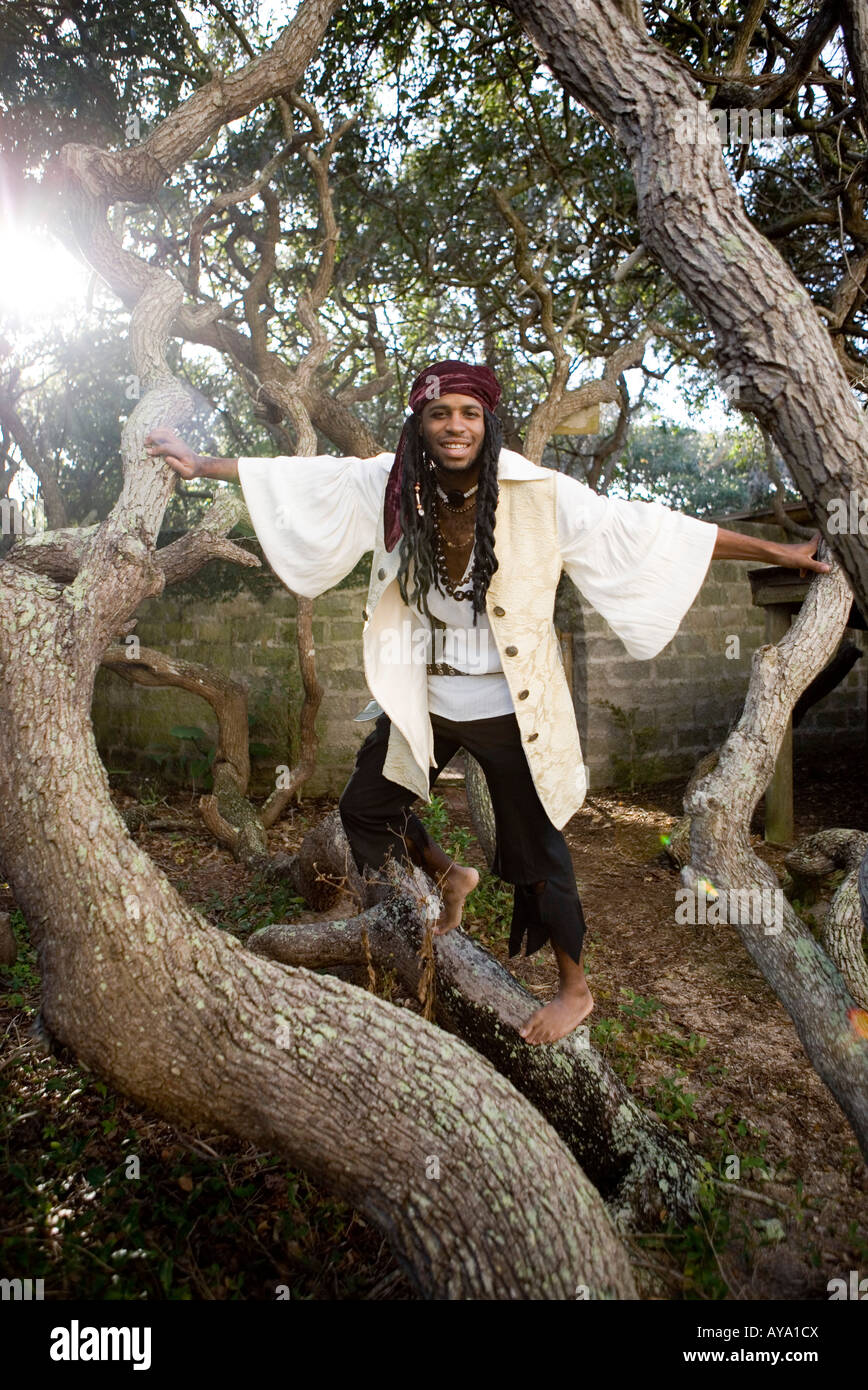 Portrait of a smiling pirate standing on a tree trunk Stock Photo - Alamy