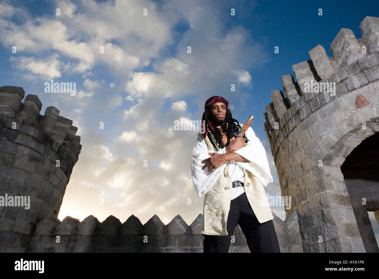 Portrait of a pirate armed with a pistol with castle turrets and ...